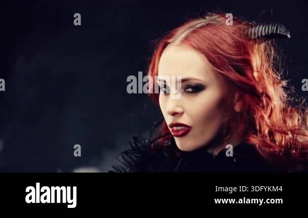 Woman smiling devilishly and cast a spell. Portrait witch witch with ...