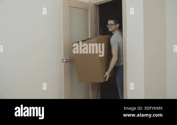 Young tired lovers bringing boxes with their personal stuff into the ...