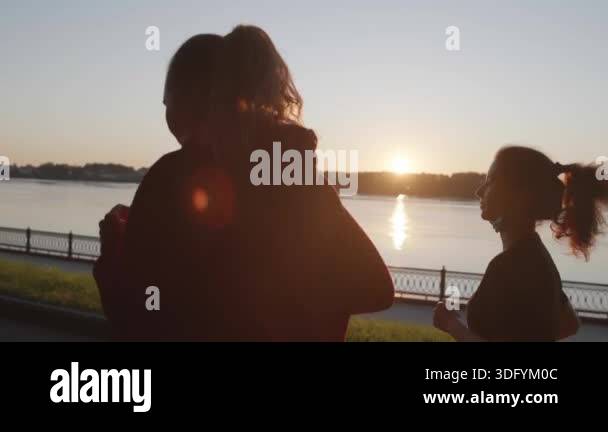 Two young girls close-up jogging in protective masks at sunrise. Social ...