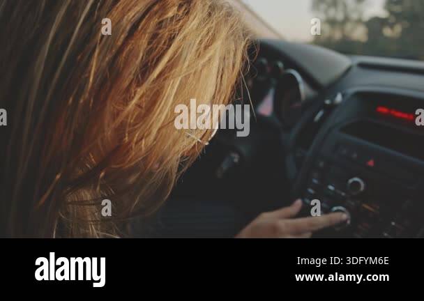 Close-up of young blonde looking for the cause of car breakdown on the ...