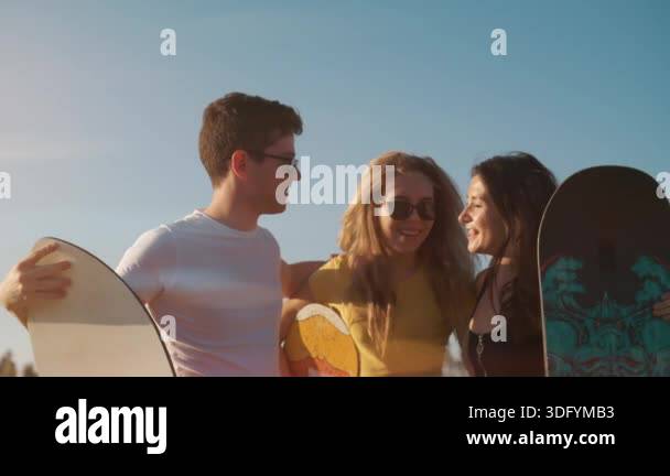 Summer outdoors. Happy smiling friends giving five on sunny evening ...