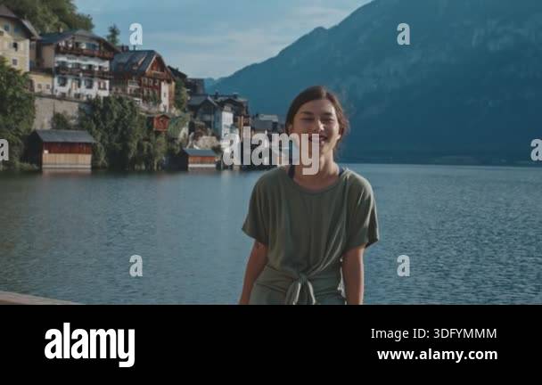 Portrait of beautiful young woman posing in front of breathtaking ...