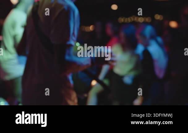 Band on stage dancing along with the crowd during performance ...