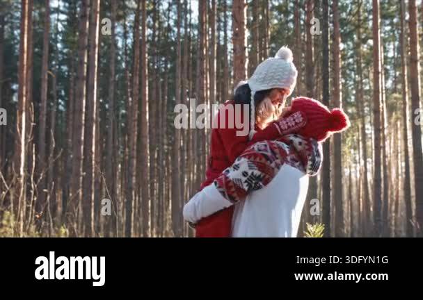 Happy young couple dating in winter forest. Xmas holidays concept ...
