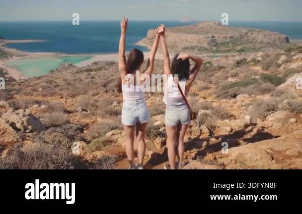 Two happy girls enjoying the vew of blue lagoon on Crete island. Travel ...