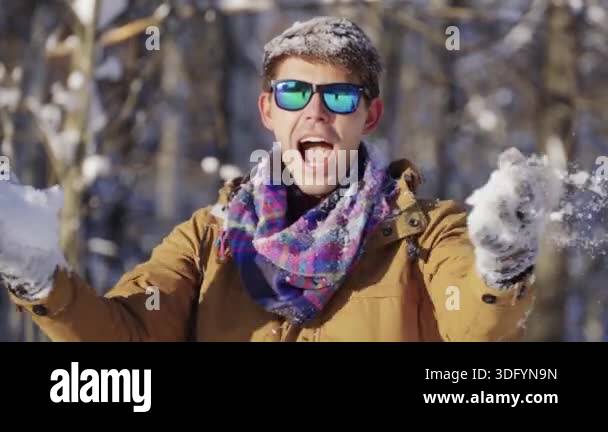 Happy teenager throwing snow up in front of camera. Winter mood. Winter ...