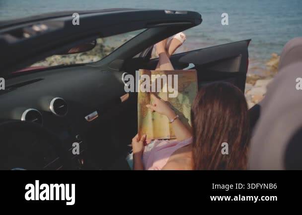 Woman studying the map in cabriolet. Travel, lifestyle. luxury, freedom ...