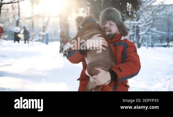 Close up of young bearded man hugging and gently kissing his cute ...