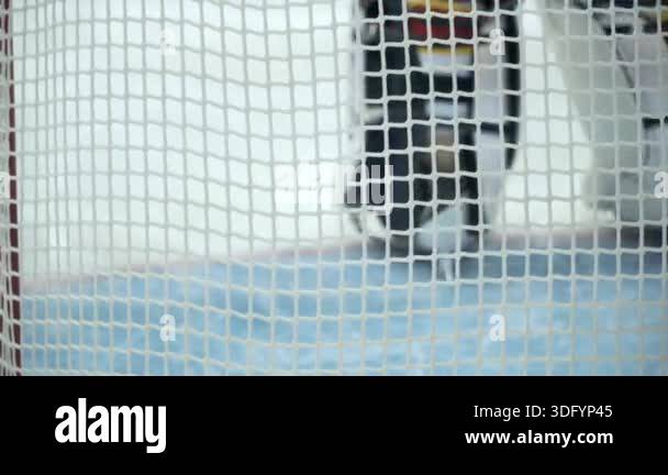 View behind the gate net on male hockey goalkeeper feet. Rear of hockey ...