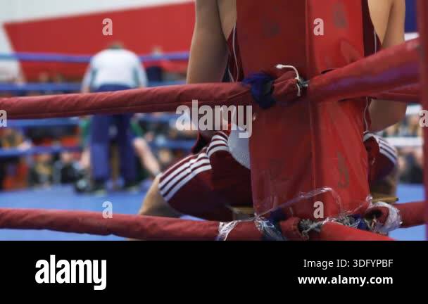Two boxers preparing for fight. Fighters in red and blue uniforms ...