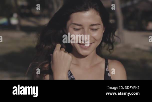 Portrait of mixed race asian woman smiling under coco palm tree ...