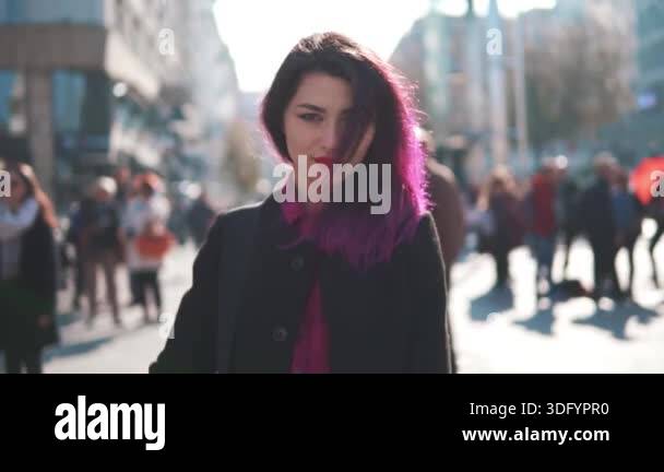 Music lifestyle. Daring rebel woman portrait with purple hair playing ...
