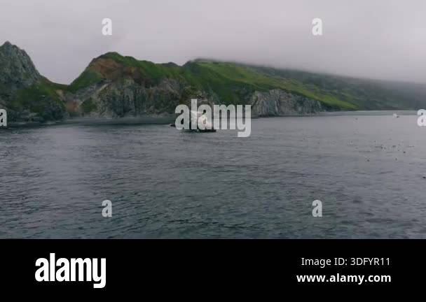 Aerial view approaching rocky coastline from quadrocopter or drone ...