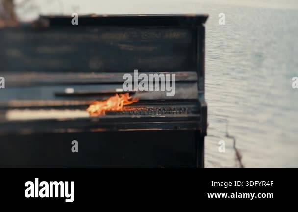 Musicial keyboard instrument piano in fire and smoke. Inferno fire ...