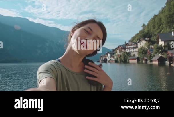 Portrait of happy young woman making selfie in front of magnifficent ...