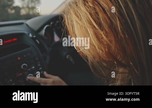 Close-up of young blonde looking for the cause of car breakdown on the ...
