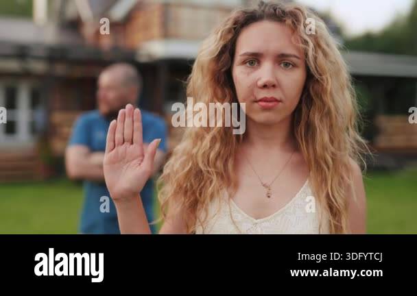 Portrait of hurt woman with scar on face showing secret gesture of ...