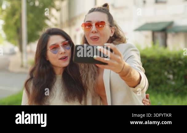 Positive emotions and love. Two young smiling hipster blond women ...