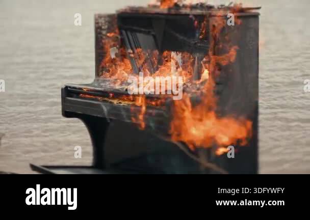 Musicial keyboard instrument piano in fire and smoke. Inferno fire ...