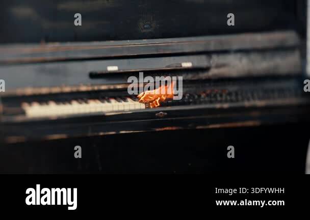 Musicial keyboard instrument piano in fire and smoke. Inferno fire ...