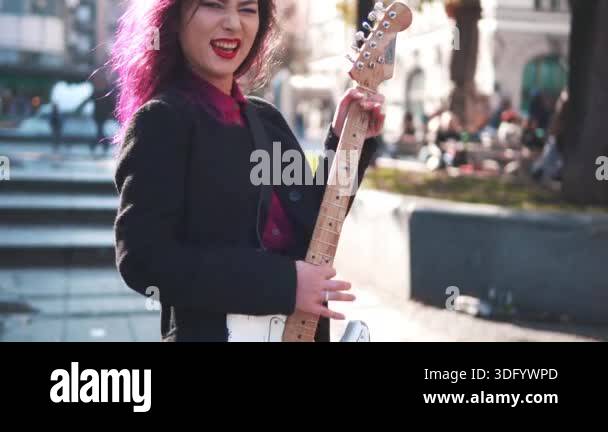 Asian girl like rock star performing show at the street. Daring rebel ...