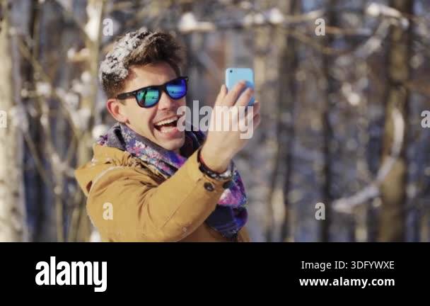 Happy guy throwing snow up in front of camera. Winter mood. Winter ...