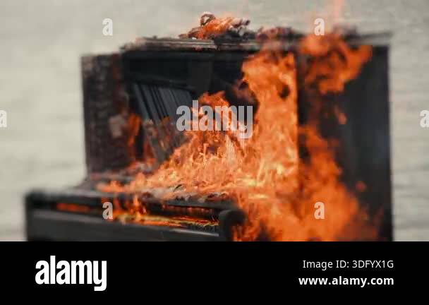 Musicial keyboard instrument piano in fire and smoke. Inferno fire ...