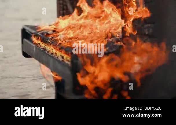 Musicial keyboard instrument piano in fire and smoke. Inferno fire ...