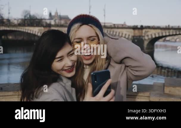 Close-up portrait of girls with smartphone or mobile phone in hands ...