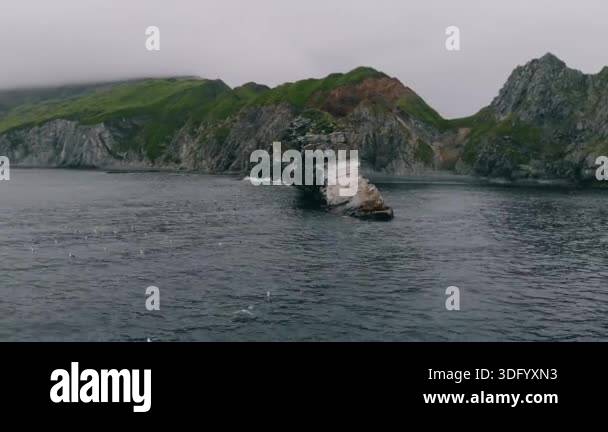 Aerial view of ocean waves splashing in front of stone rocks. Video ...