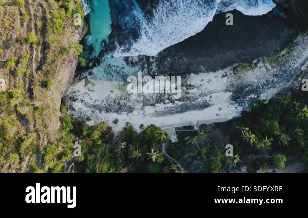 Concept of travel. Magnifficent top down view of sea tides crashing ...