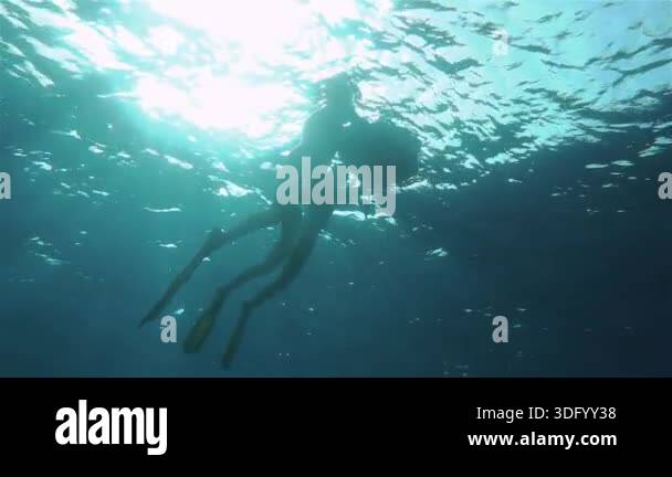 free divers relaxing on the buoy, slow motion shot. Freediving is a ...