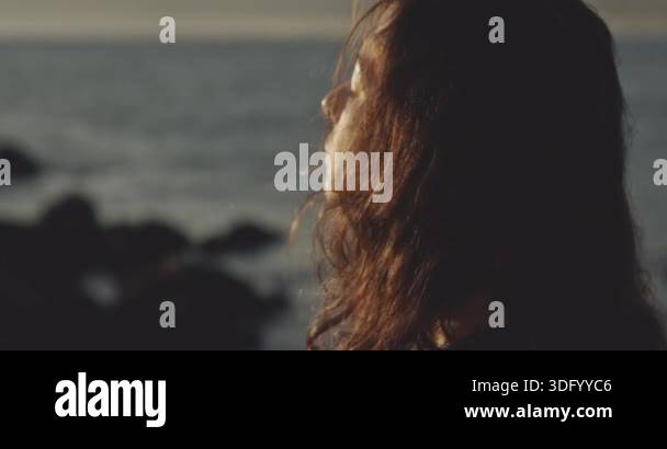 Woman with closed eyes at sunset, filmed on cinematic camera, 12 bit ...