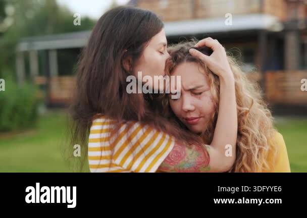 Woman with a scar on her face crying and hugging her friend. Woman ...