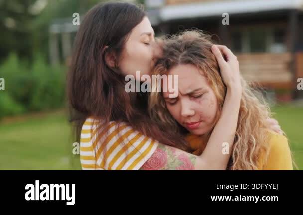 Woman becalm or console a victim of domestic violence. Woman with a ...