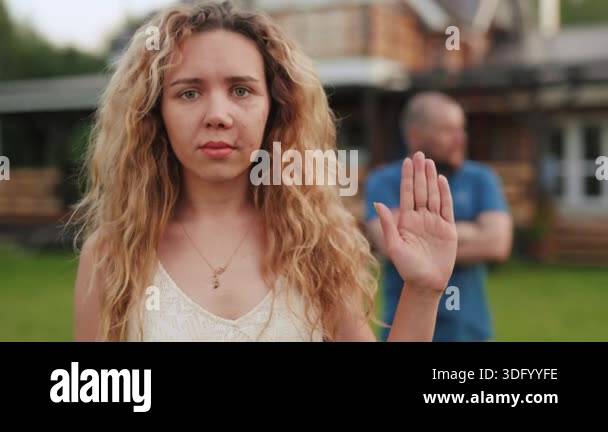 Portrait of hurt woman with scar on face showing secret gesture of ...
