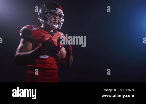 Portrait of determined professional American football player in helmet ...