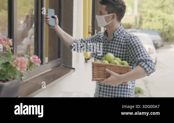 Employee worker or delivery man brings food to womans home. Woman pay ...