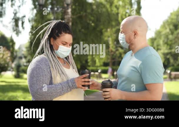 Two friends meet, drink coffee, put off medical mask, deeply breath and ...