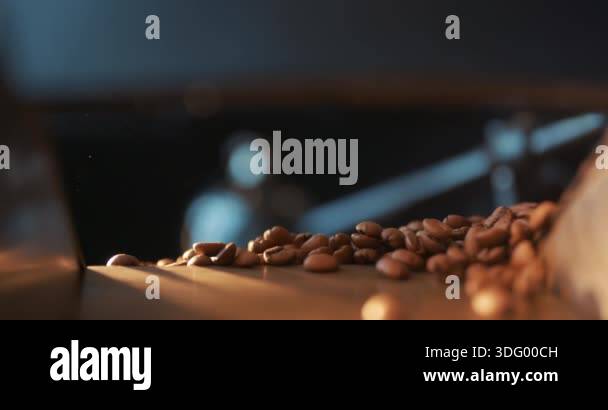Roasted coffee beans fly and spin on a black background in slow motion ...