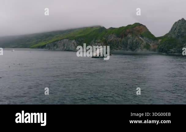 Aerial view approaching rocky coastline from quadrocopter or drone ...