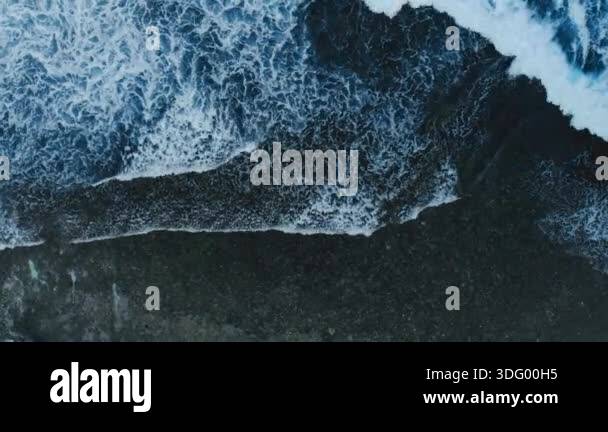 Mysterious black sand beach and foam waves. View from the top. Look ...