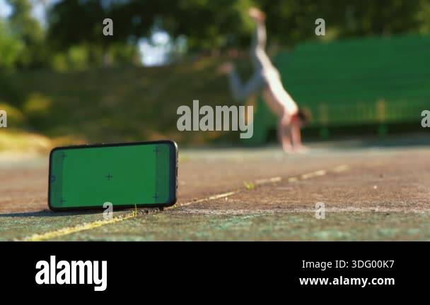 In foreground is horizontal screen of smartphone or mobile phone with ...