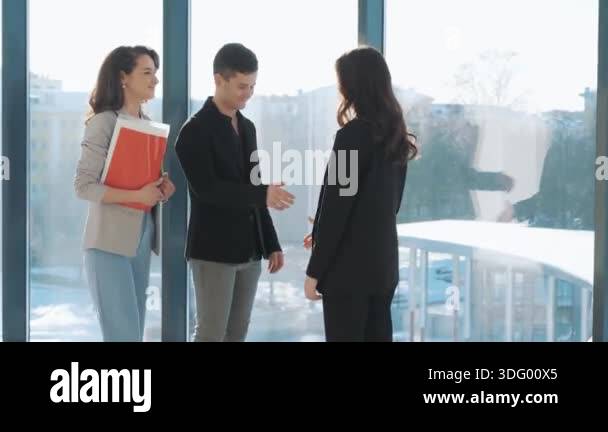 Portrait of two casual looking businesswoman and man meeting with ...