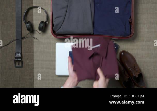 Businessman packing a suitcase for a trip. Young girl getting ready for ...