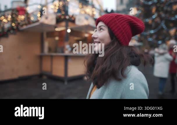 Portrait of beautiful young woman in a center of christmas fair. Girl ...