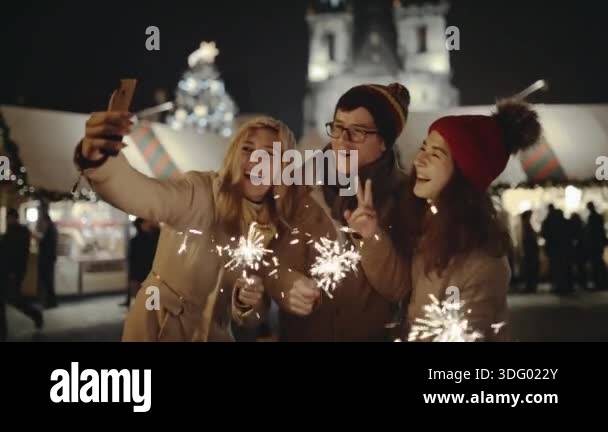 Group of friends taking a selfie with smartphone on the Christmas ...