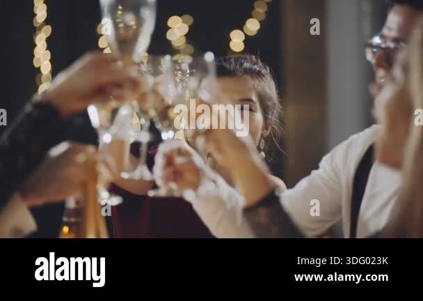 Millennials at party or holiday sitting at table, drinking champagne ...