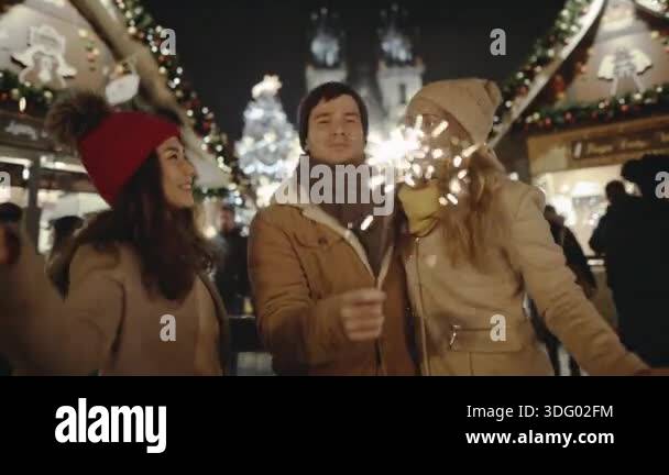 Laughing group of friends having fun at the Christmas Fair. People ...