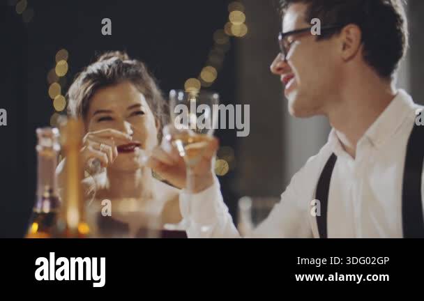 Close shot of portraits of young couple talking at table during holiday ...